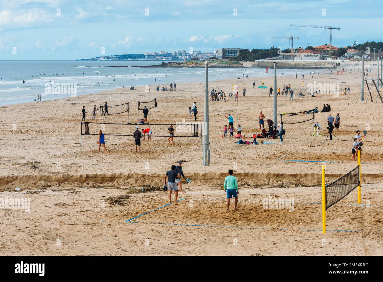 High perspective view of people practicing beach tennis and surf at ...