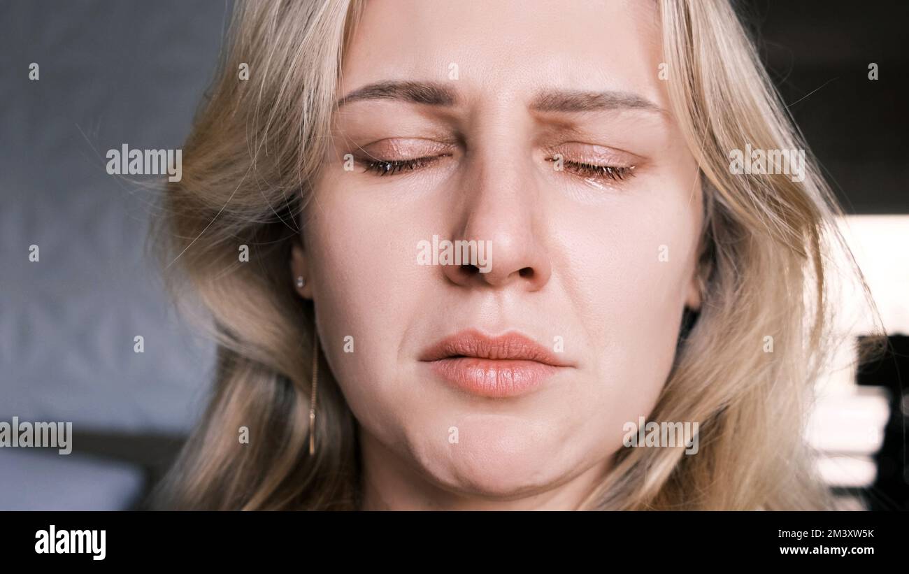 Portrait of crying grieving woman of 30 years. Grimace of sadness with ...