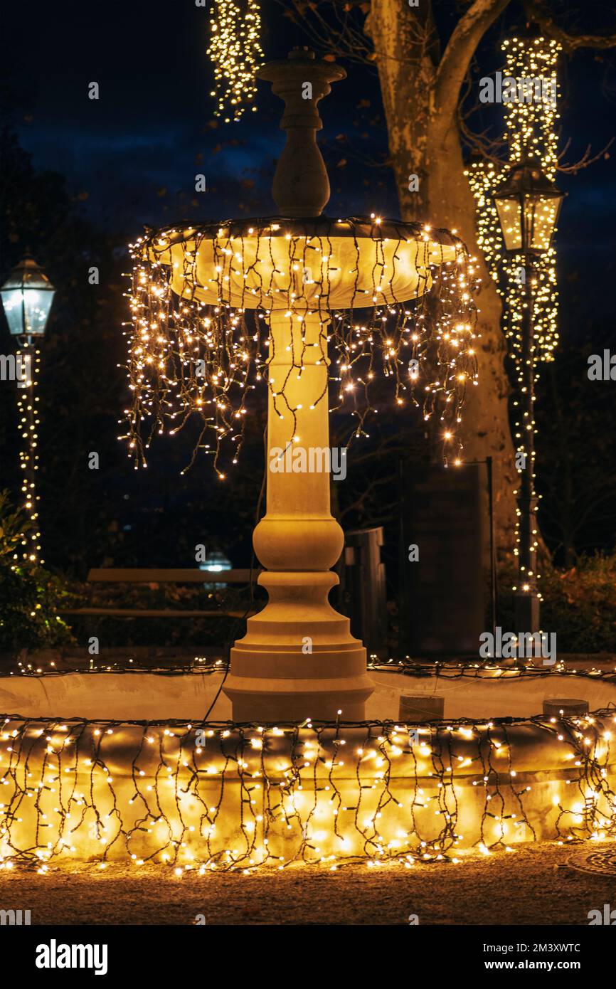 Fountain in the park decorated for Christmas at night Stock Photo - Alamy