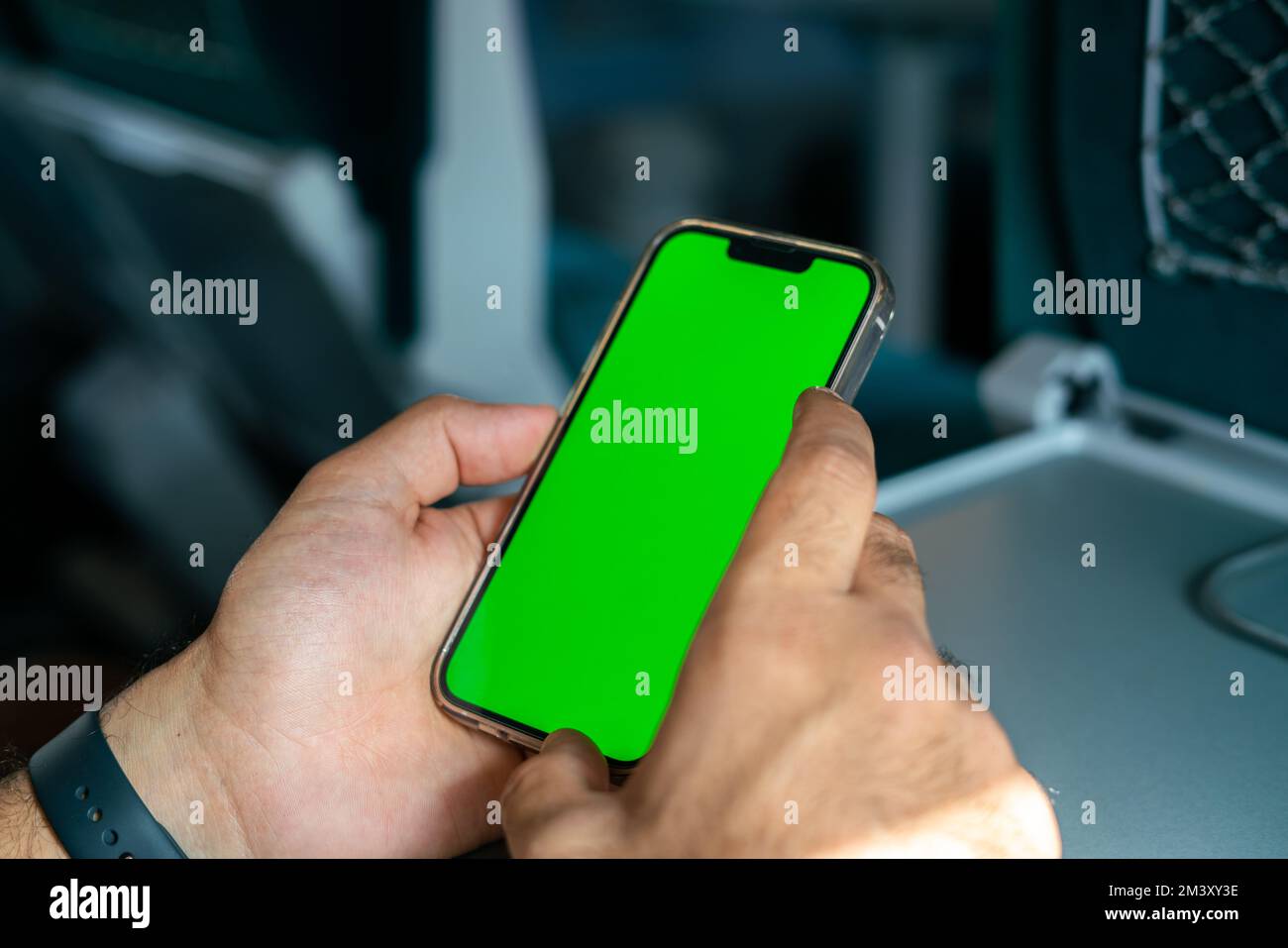 Unidentified man holding a smartphone with green screen Stock Photo - Alamy