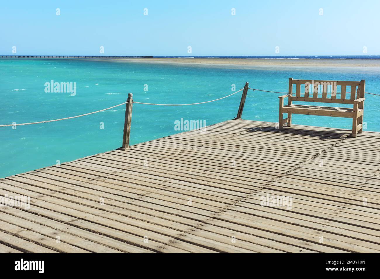Empty bench at a sea pier, summer vacation concept Stock Photo - Alamy