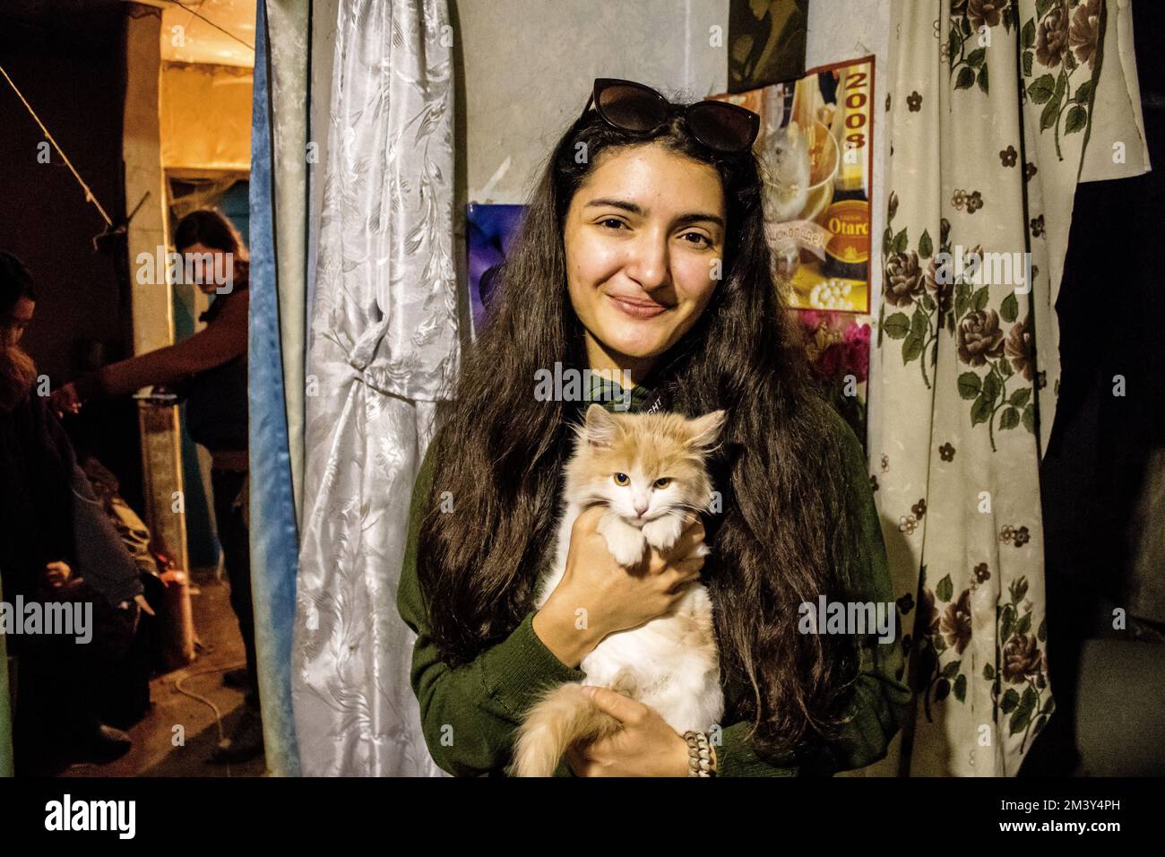 Portrait of Manushak affectionately posing with her cat in a combat ...