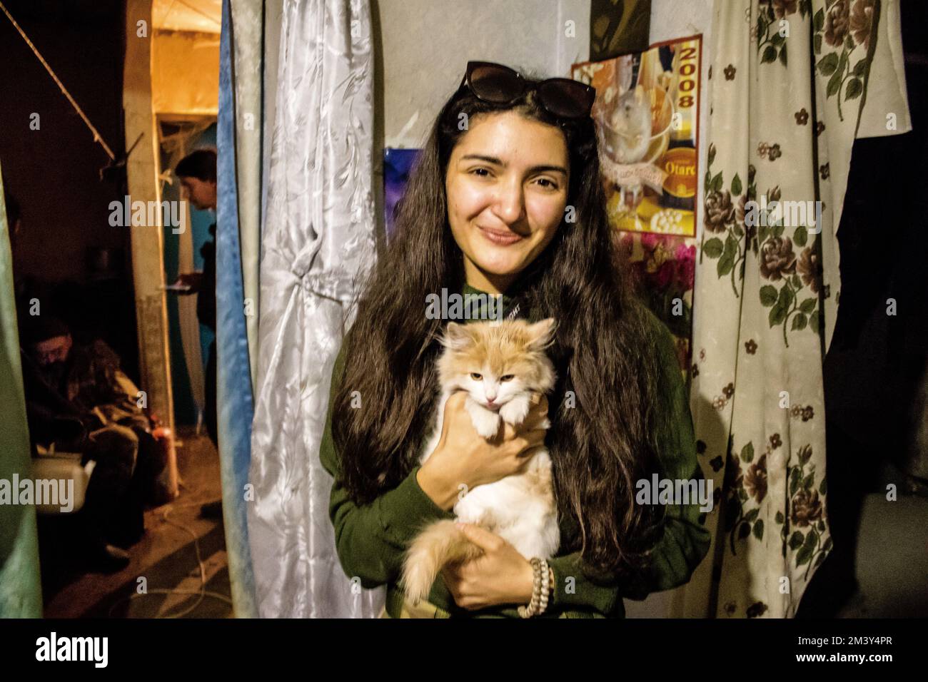 Portrait of Manushak affectionately posing with her cat in a combat ...