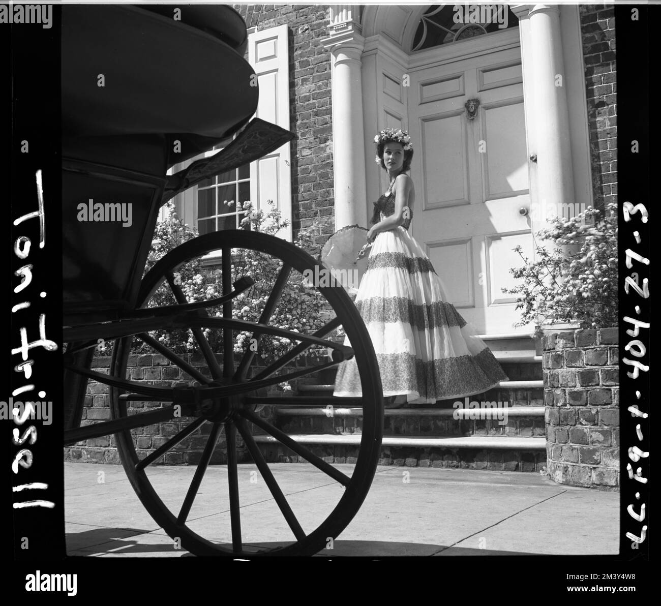 Mrs. Stanley Mortimer posing in an evening gown, with parasol, on the ...