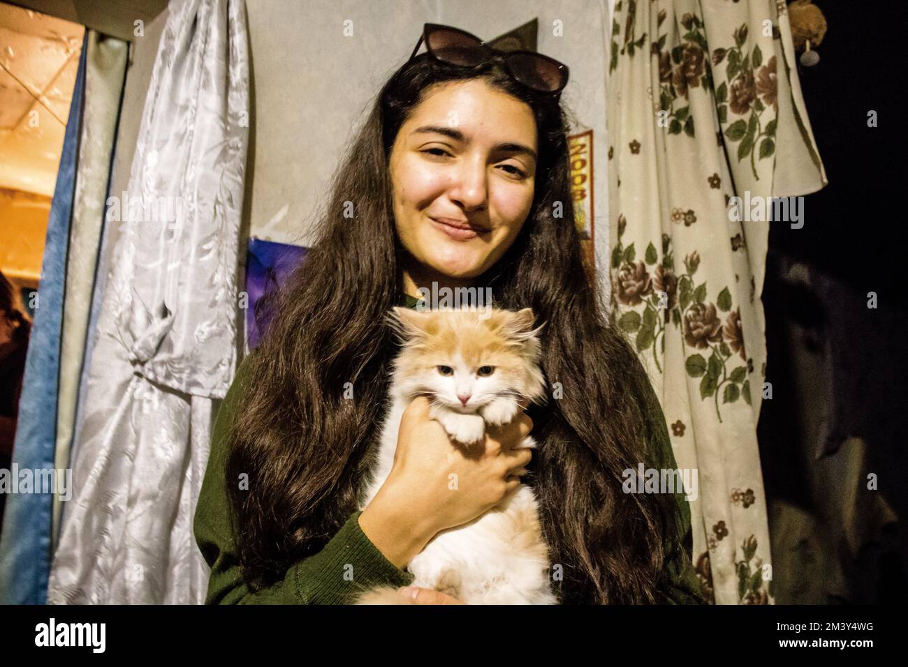 Portrait of Manushak affectionately posing with her cat in a combat ...