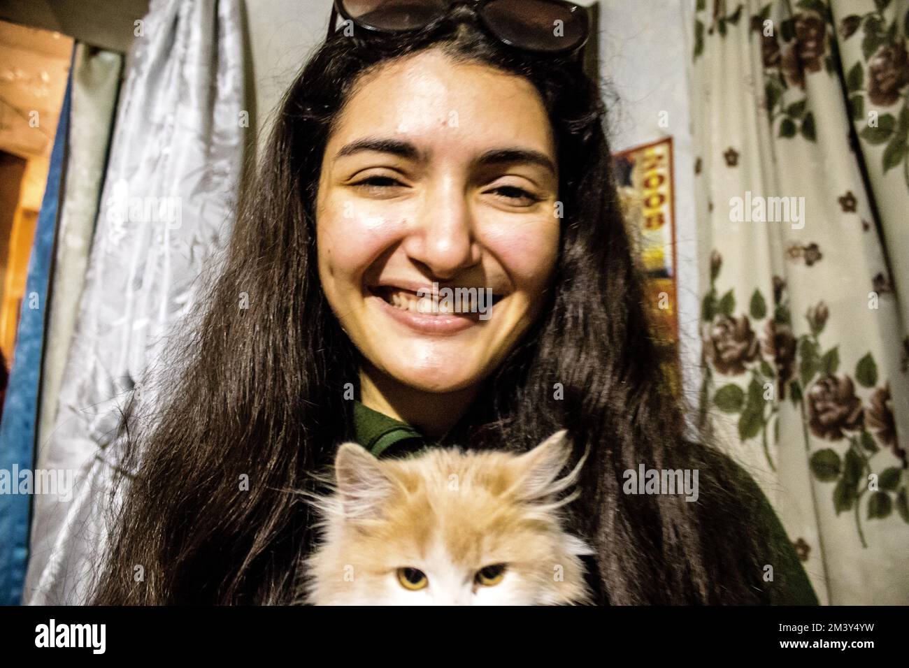 Portrait of Manushak affectionately posing with her cat in a combat ...