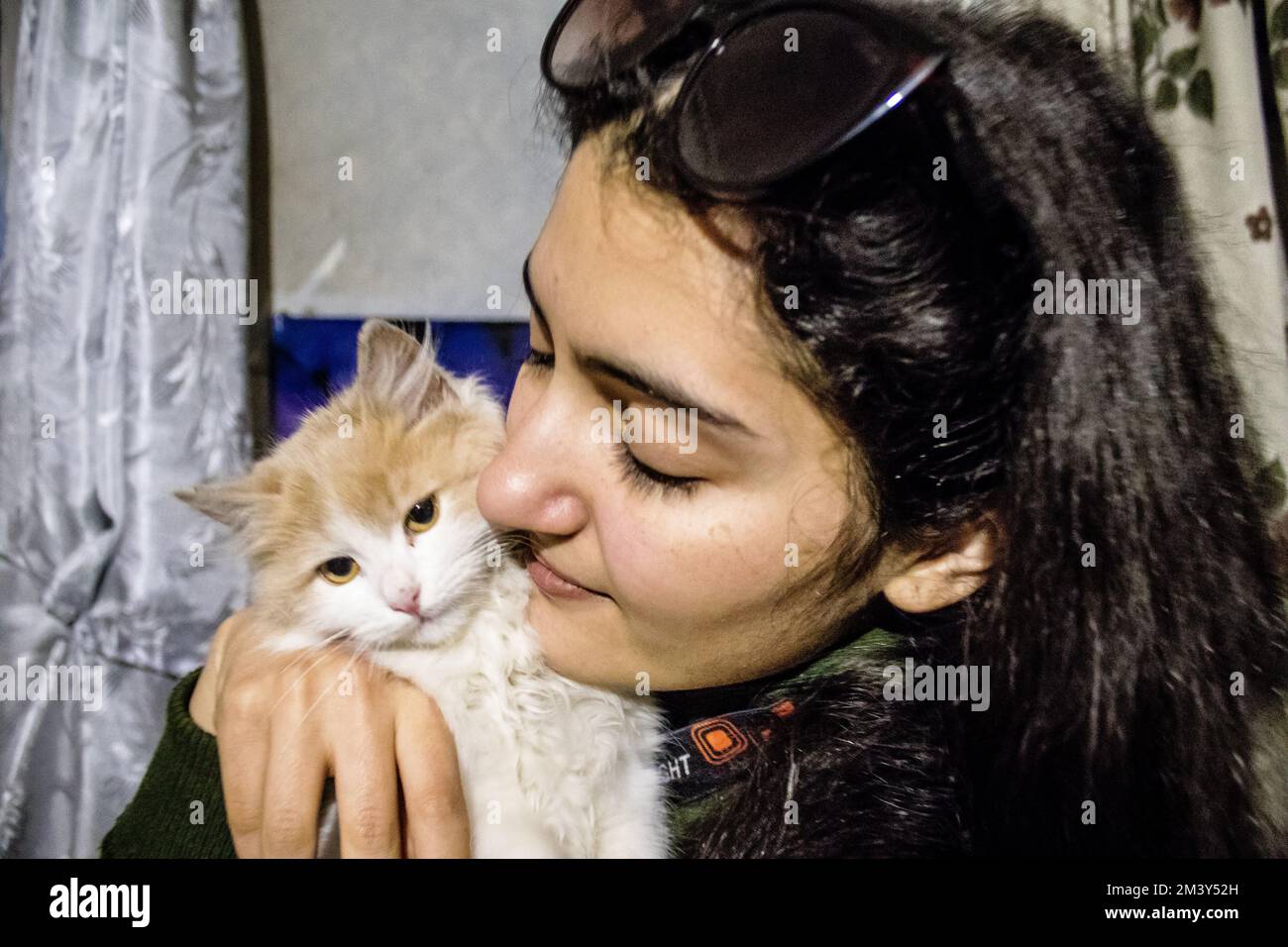 Portrait of Manushak affectionately posing with her cat in a combat ...