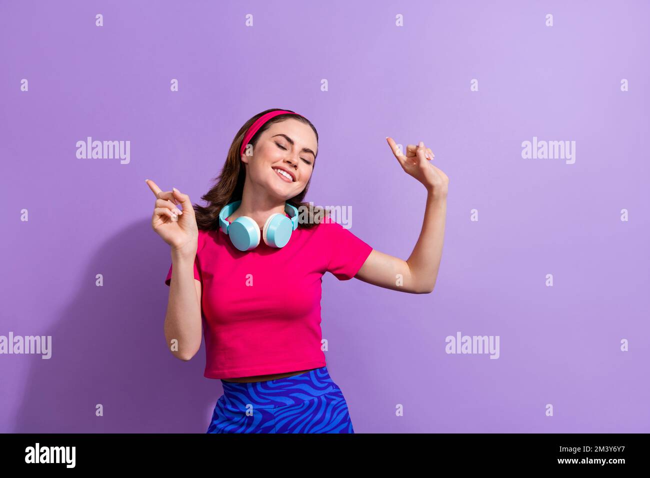 Portrait of pretty cheerful lady closed eyes point fingers dancing ...