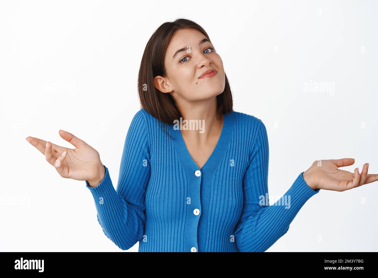 Dont know, not care. Smiling unbothered brunette girl shrugging ...