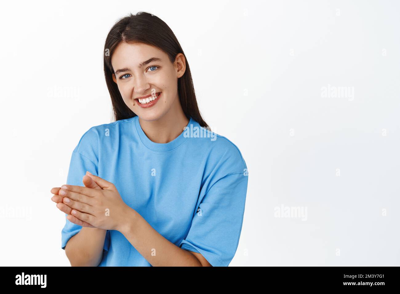 Close up of smiling brunette girl clap hands, looking pleased, praising ...