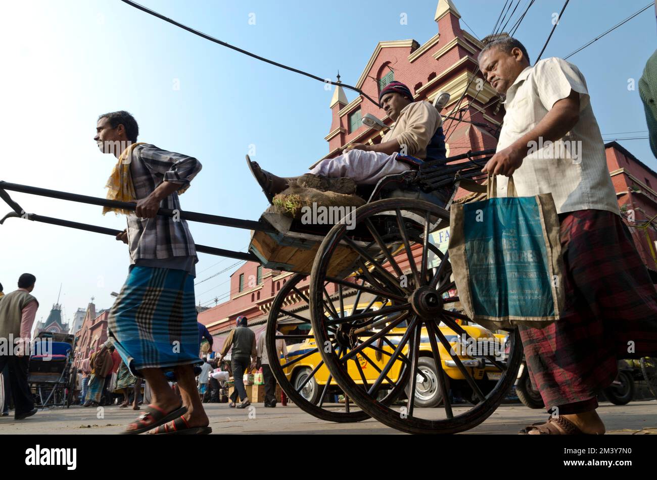 A rikshaw-wala is pulling a costumer in the street Stock Photo - Alamy