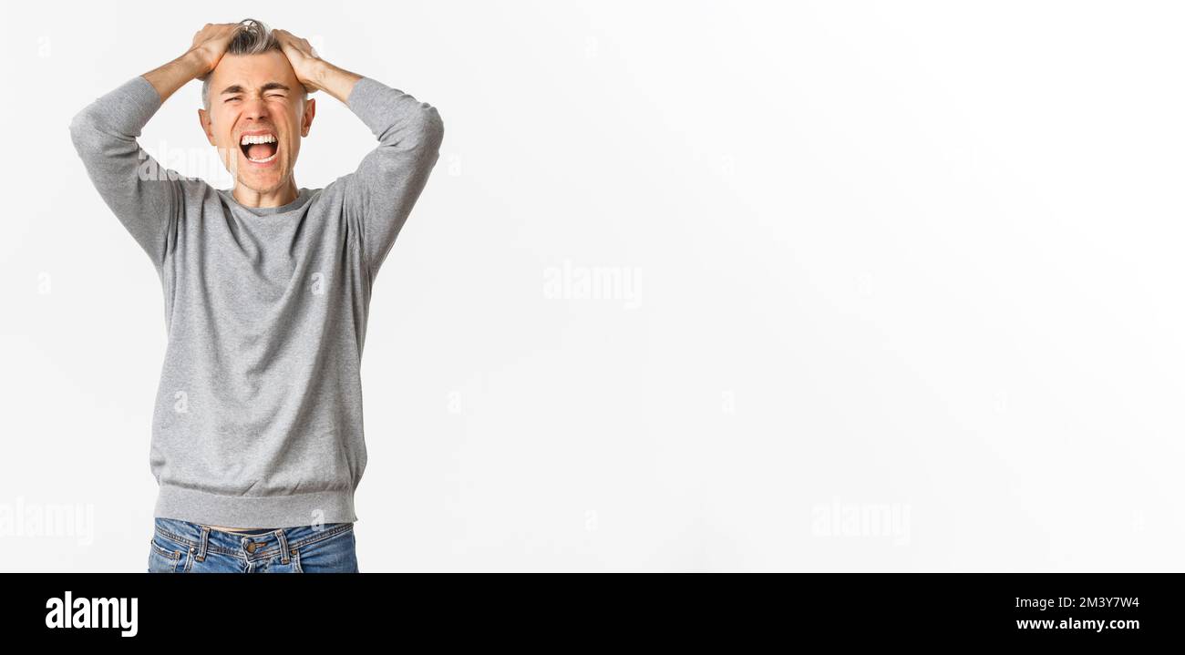 Image of frustrated middle-aged man panicking, losing something ...