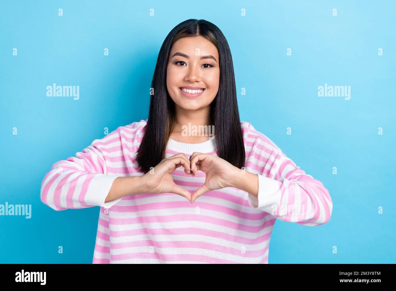 Photo of sweet shiny young lady wear striped sweater showing fingers ...
