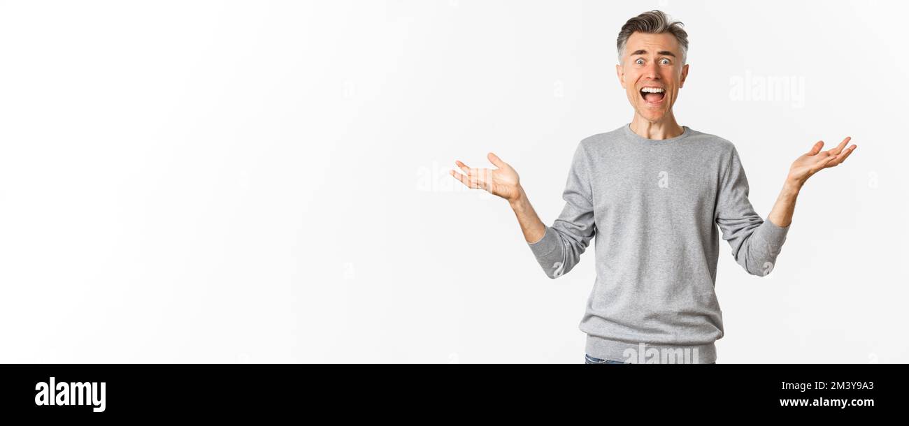 Image of shocked and frustrated man spread hands sideways, shouting and ...