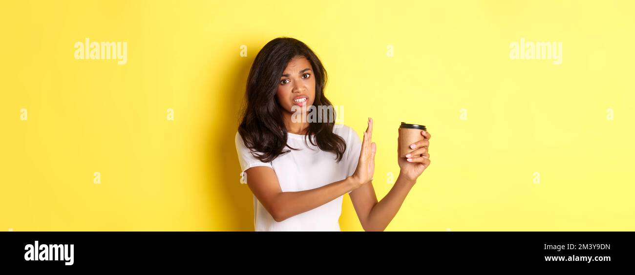 Image of african-american girl complaining about bad taste of coffee ...