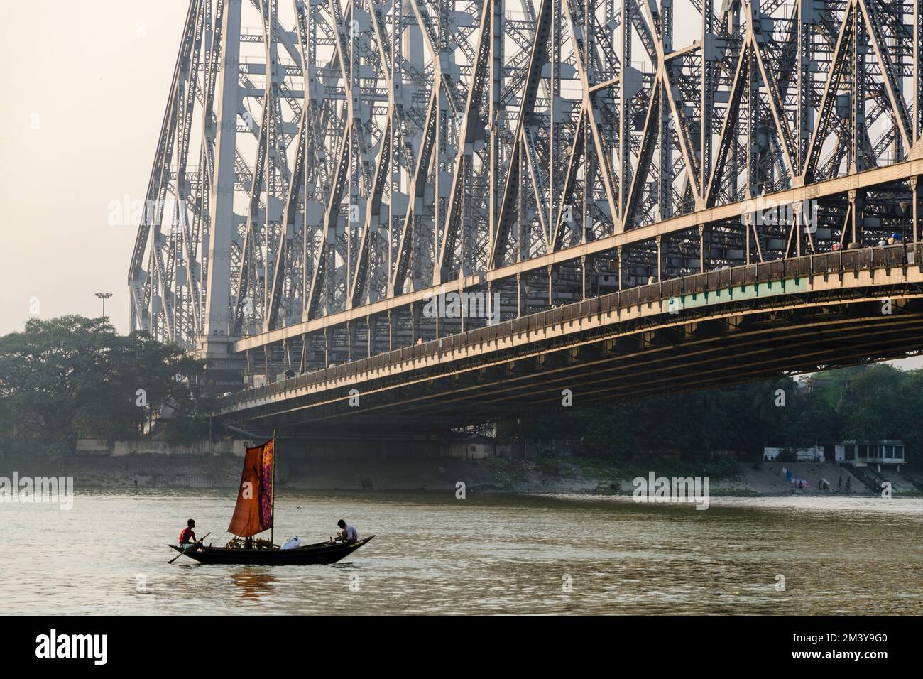 An old sailing boat is passing the impressive construction of the 705 m ...