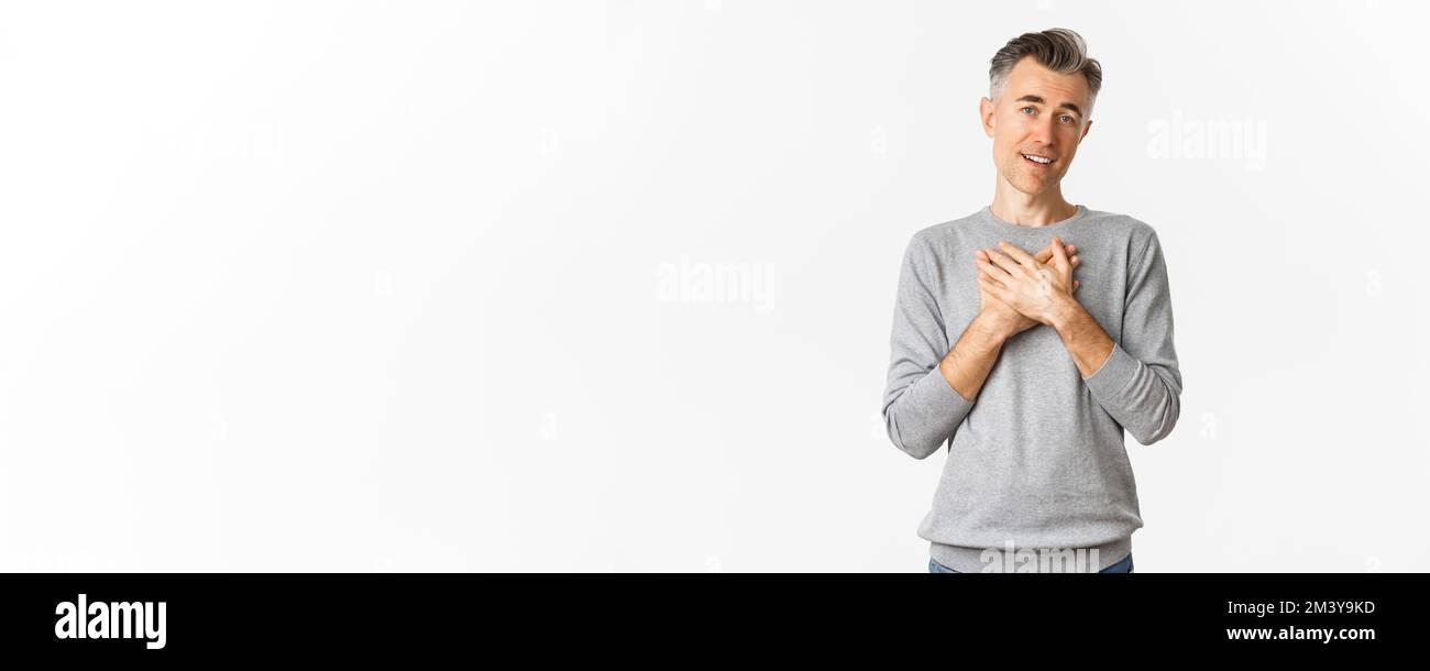 Image of pleased and happy adult man with gray hair, holding hands on ...