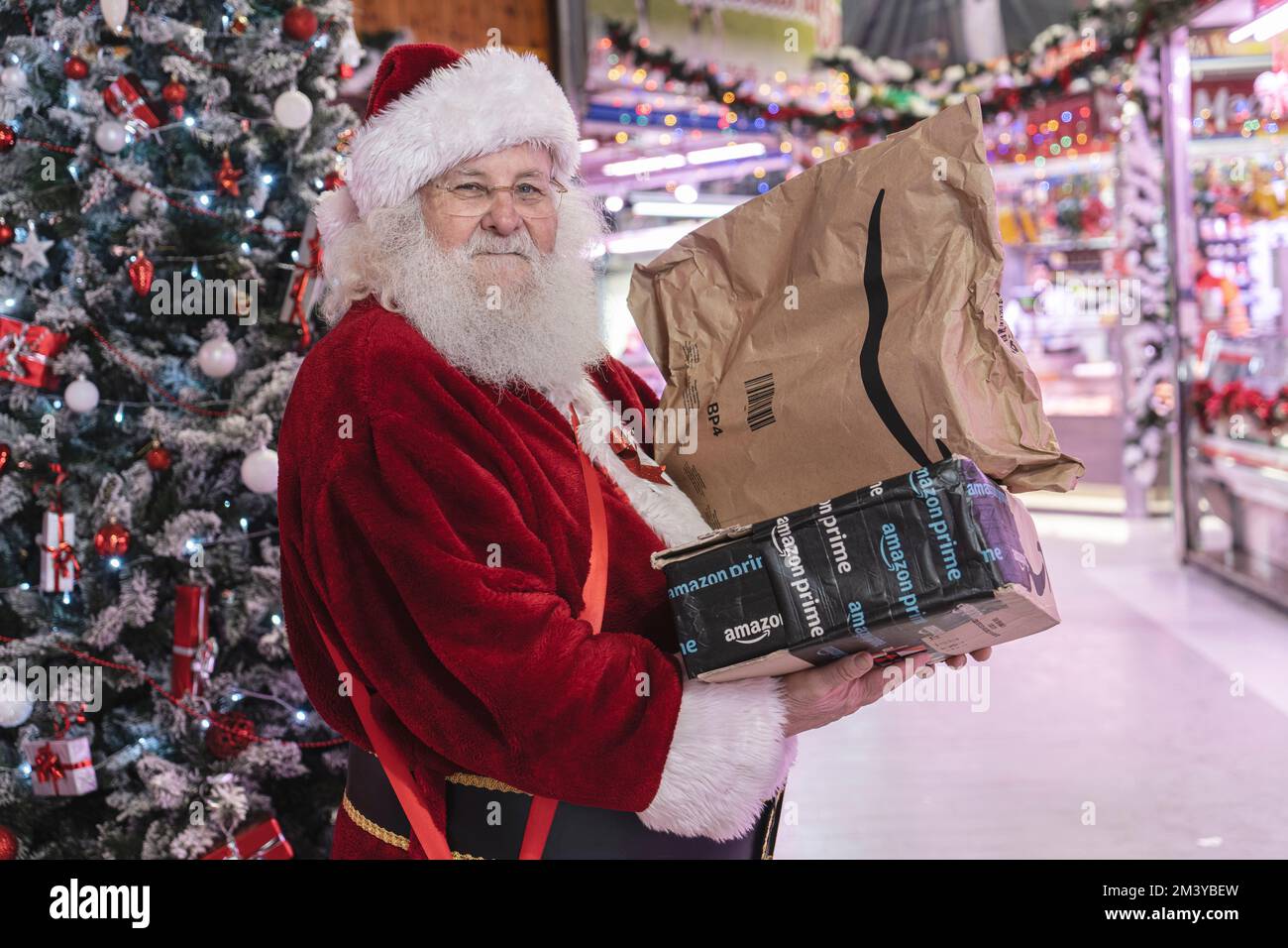 Santa Claus holding Christmas gifts ordered from Amazon. Milan Italy ...