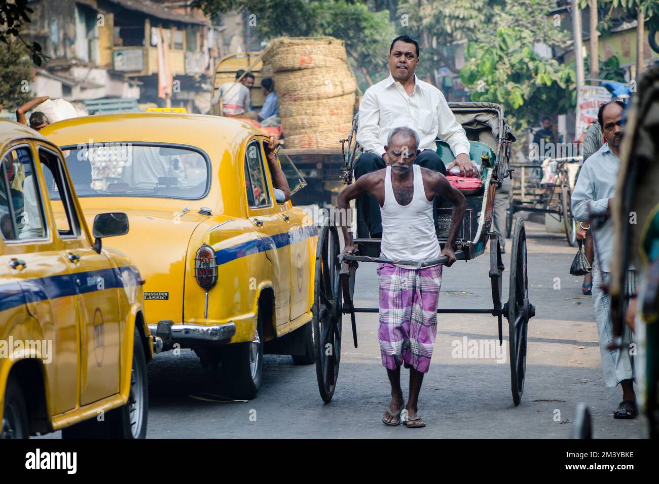 Hand pulled rikshaws are still common in the streets Stock Photo - Alamy