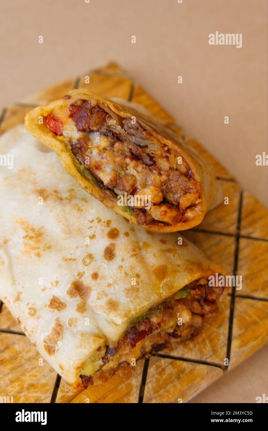 A Pastor mexican burrito with meat and hot sauce Stock Photo - Alamy