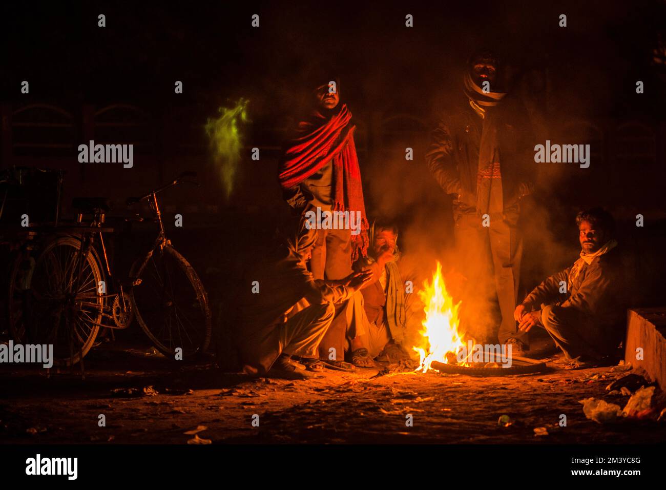 Security guards surrounding the Taj Mahal area, warming at a bonfire ...