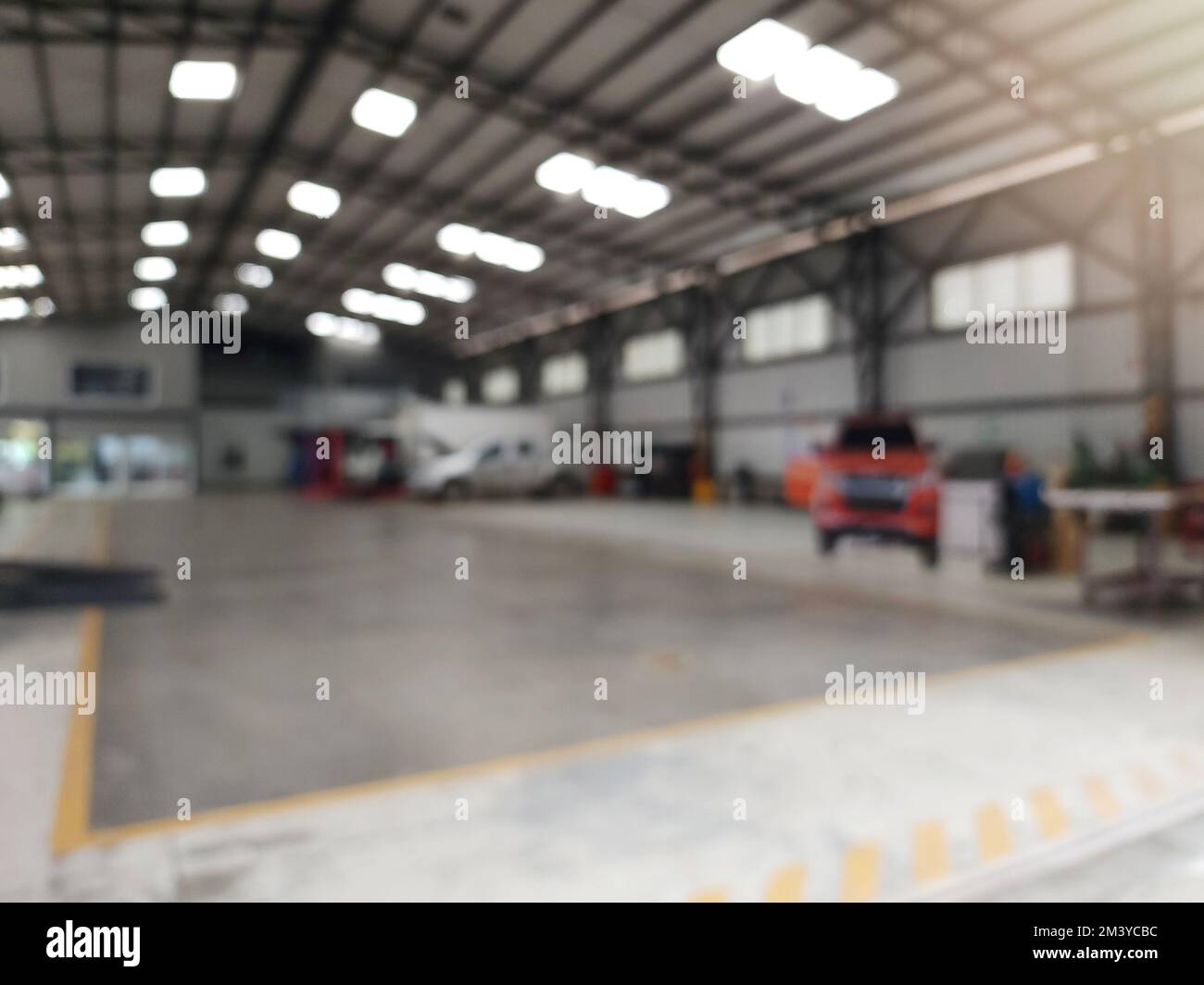 Maintenance car area blurred background. Big car garage Stock Photo - Alamy