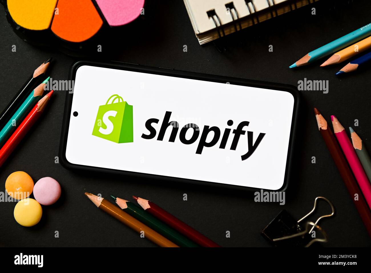 In this photo illustration a Shopify logo seen displayed on a ...