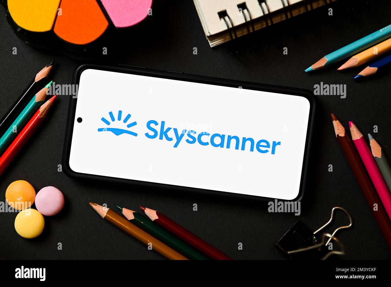 In this photo illustration a Skyscanner logo seen displayed on a ...