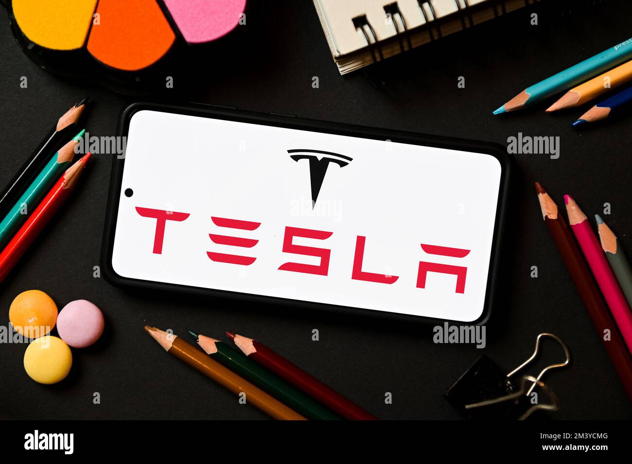 In this photo illustration a Tesla logo seen displayed on a smartphone ...