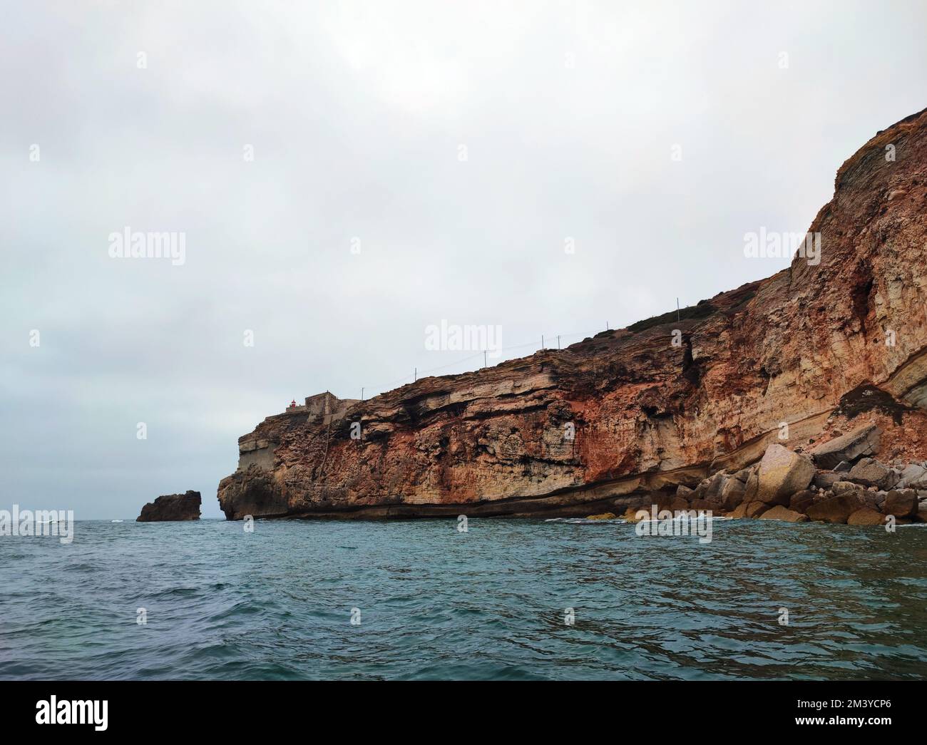 A beautiful view of cliffs at the beach under a cloudy sky Stock Photo ...