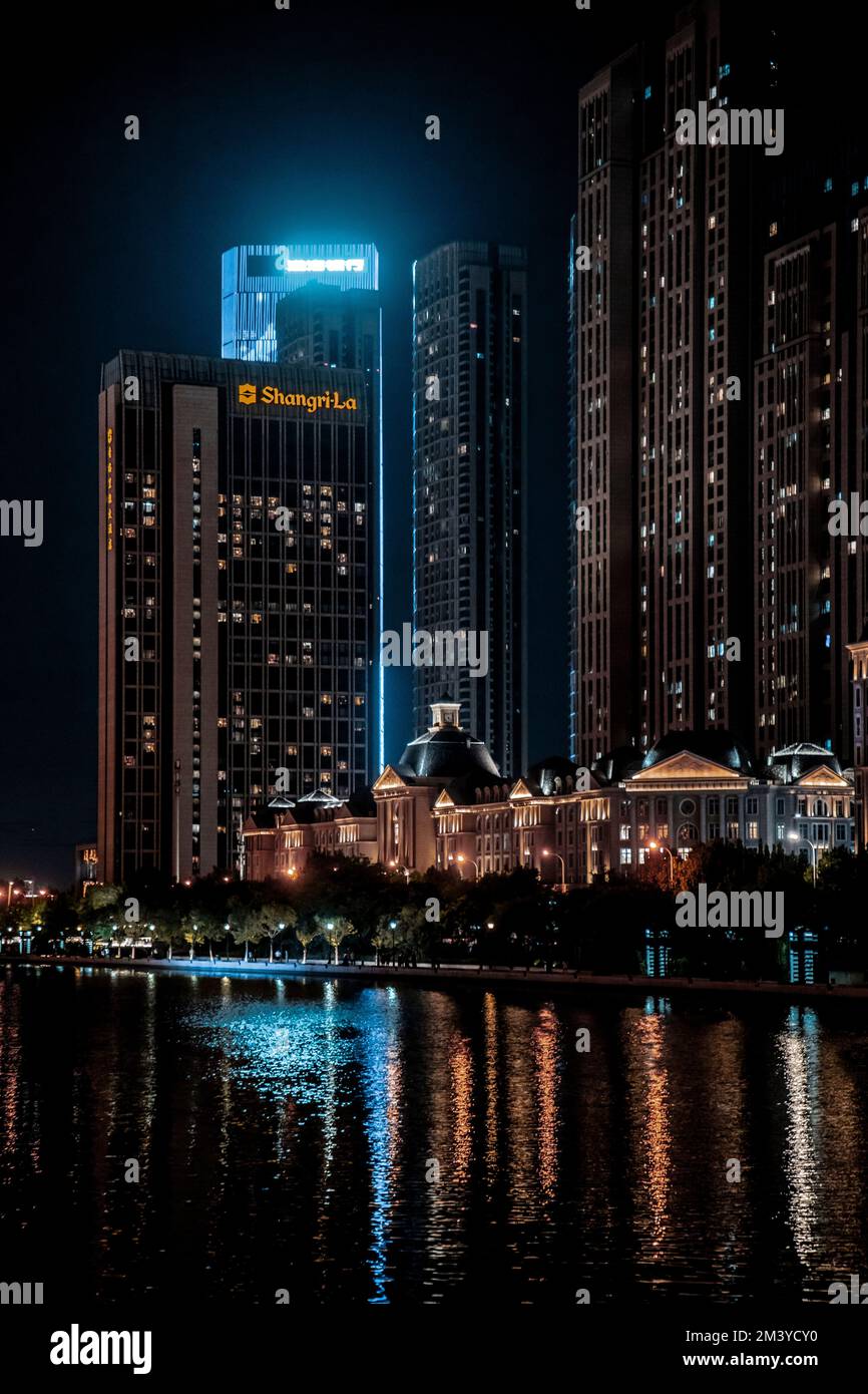 A night scene with illuminated buildings by the Haihe River on dark ...