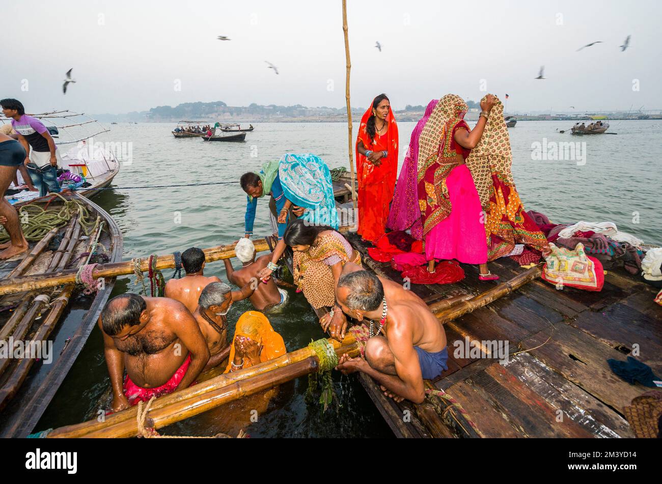 Pilgrims taking their holy dip into the water at Sangam, the confluence ...