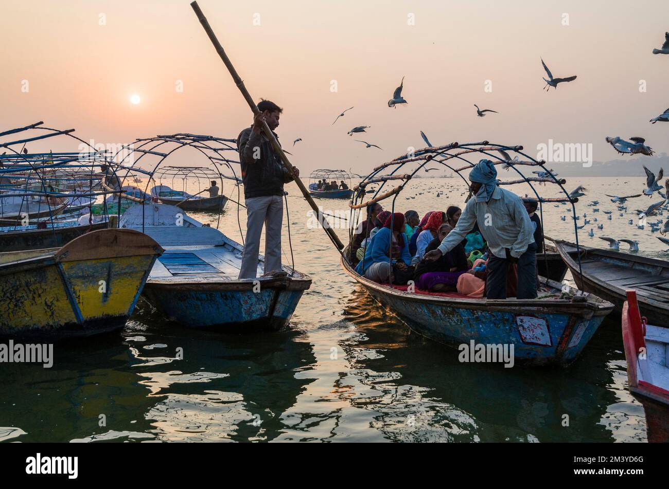 Boats with pilgrims at Sangam, the confluence of the holy rivers Ganges ...