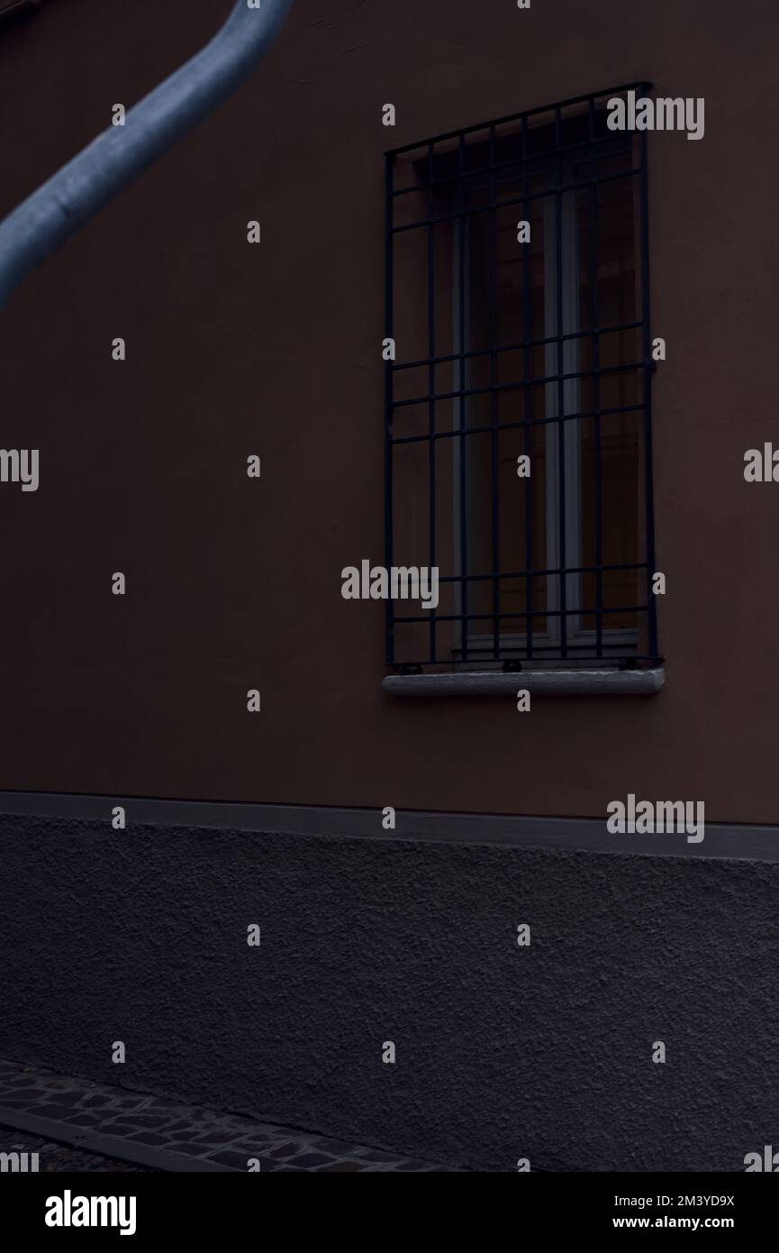Window with a grate in a facade Stock Photo - Alamy