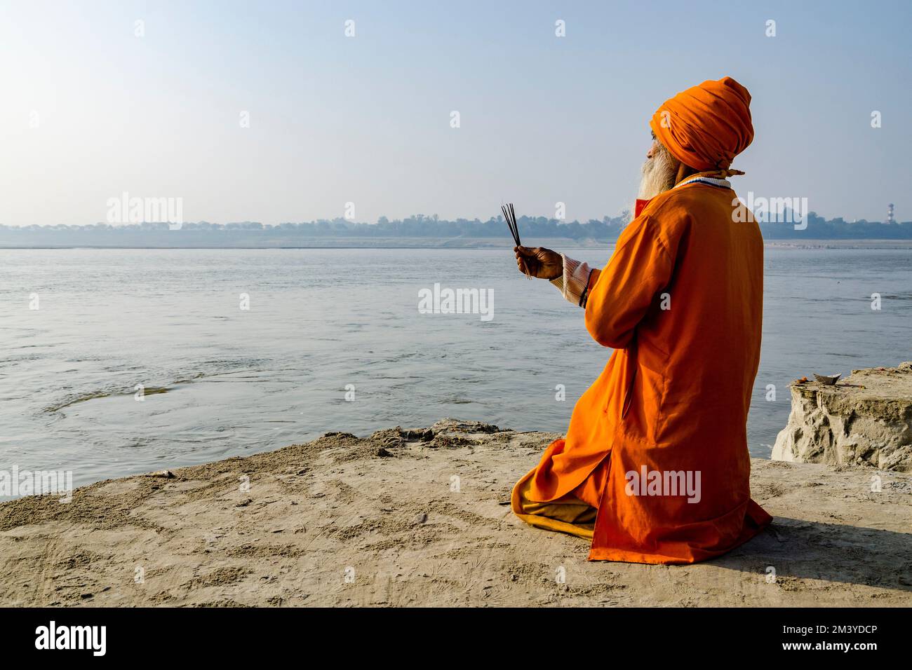 Sadhu, holy man, praying at Sangam, the confluence of the holy rivers ...