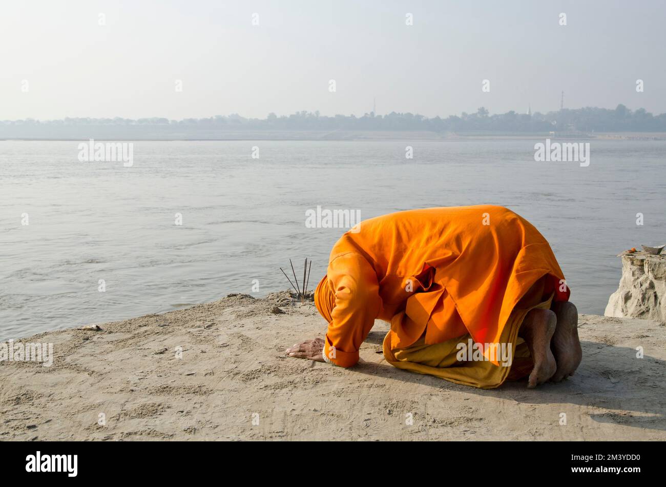 Sadhu, holy man, praying at Sangam, the confluence of the holy rivers ...