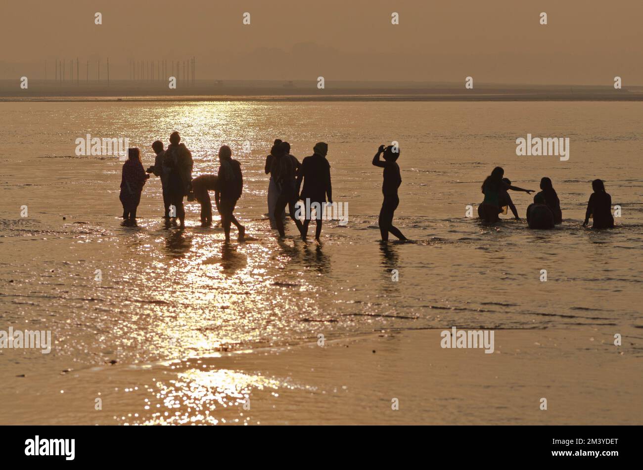 Pilgrims standing in the water at Sangam, the confluence of the holy ...