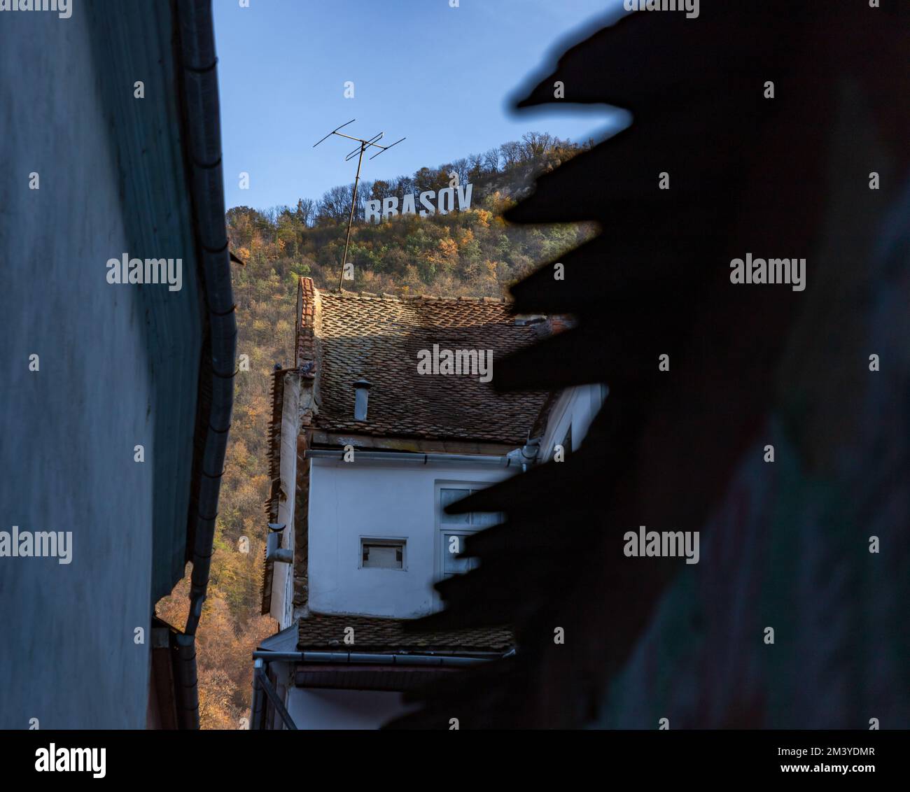 A picture of the Brasov sign as seen from a narrow alley Stock Photo ...