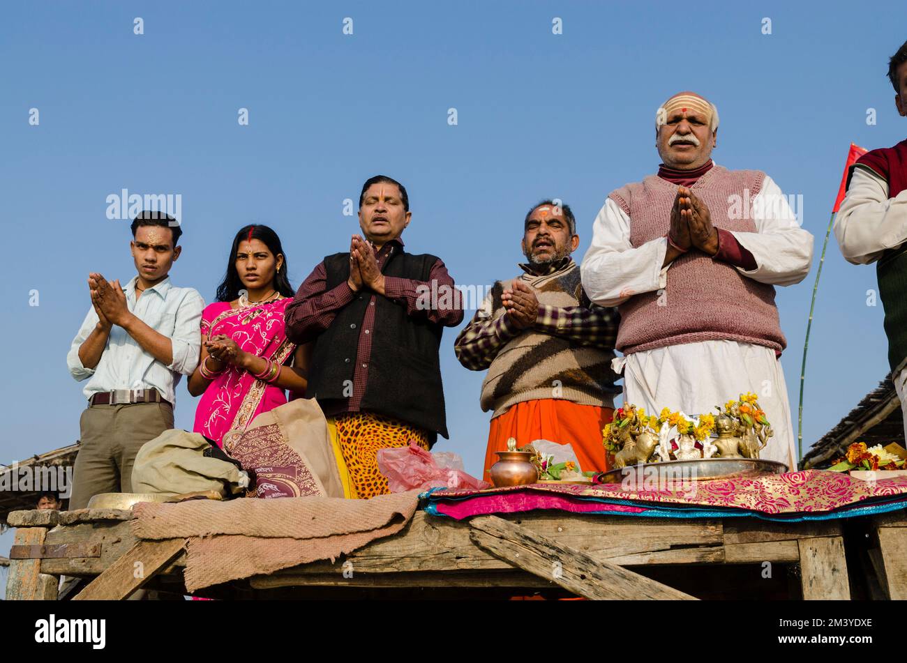 Pilgrims praying at Sangam, the confluence of the holy rivers Ganges ...