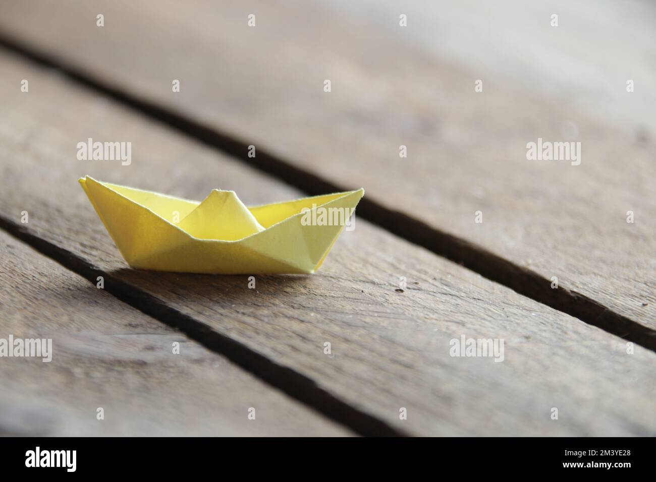Beautiful paper boat on a vintage wooden background Stock Photo - Alamy