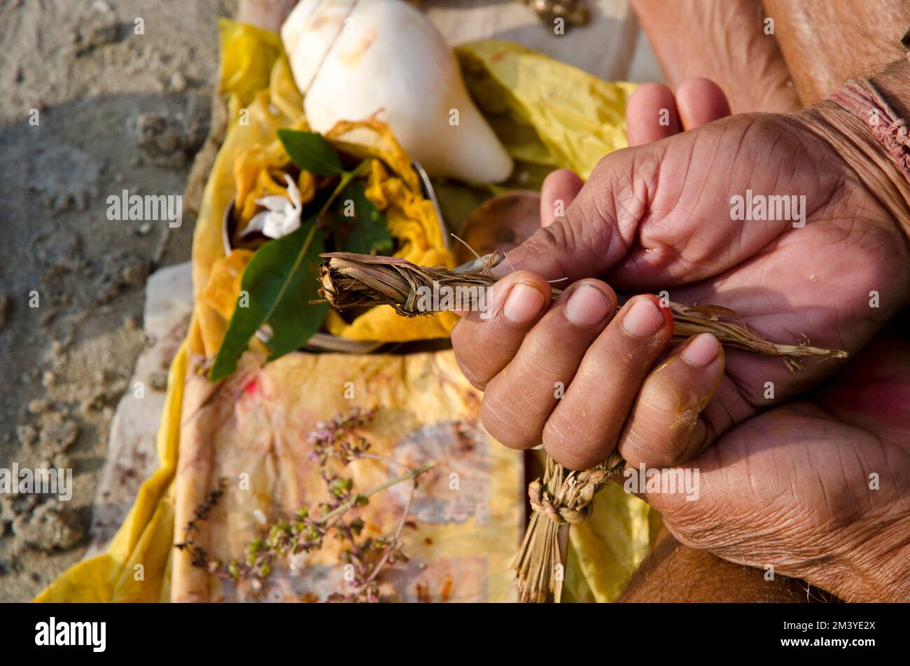 Hands of pilgrims, performing religious rituals at Sangam, the ...