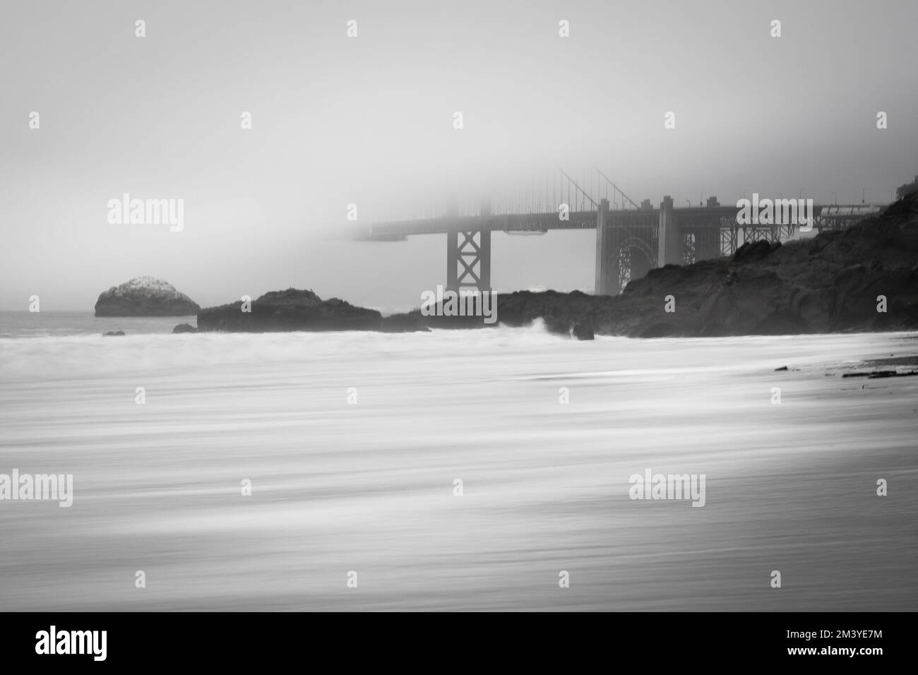 A grayscale shot of the Golden Gate Bridge, San Francisco, in the fog ...