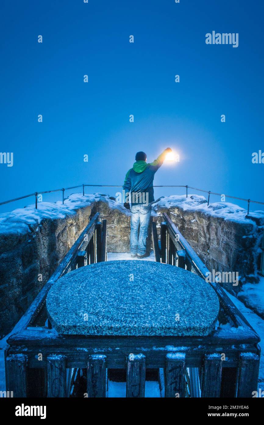 A vertical shot of a boatswain standing on Titanic ship's bow holding a ...