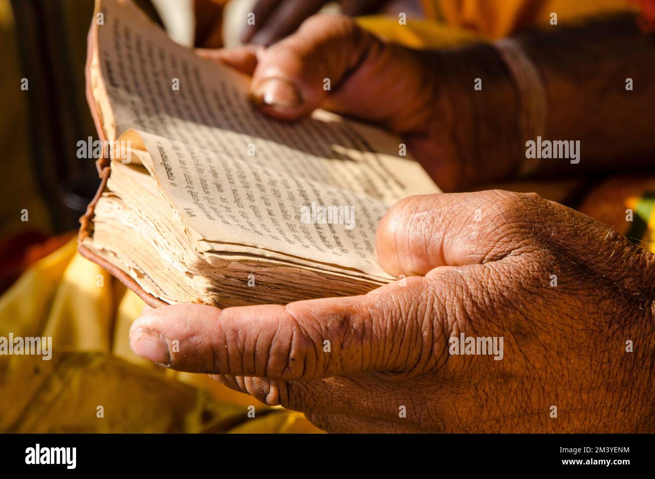 Hands of a Sadhu reciting from the holy books in the morning at Sangam ...