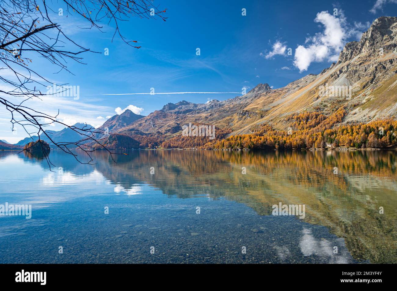 Fantastic reflections of the sky and mountains covered with golden ...