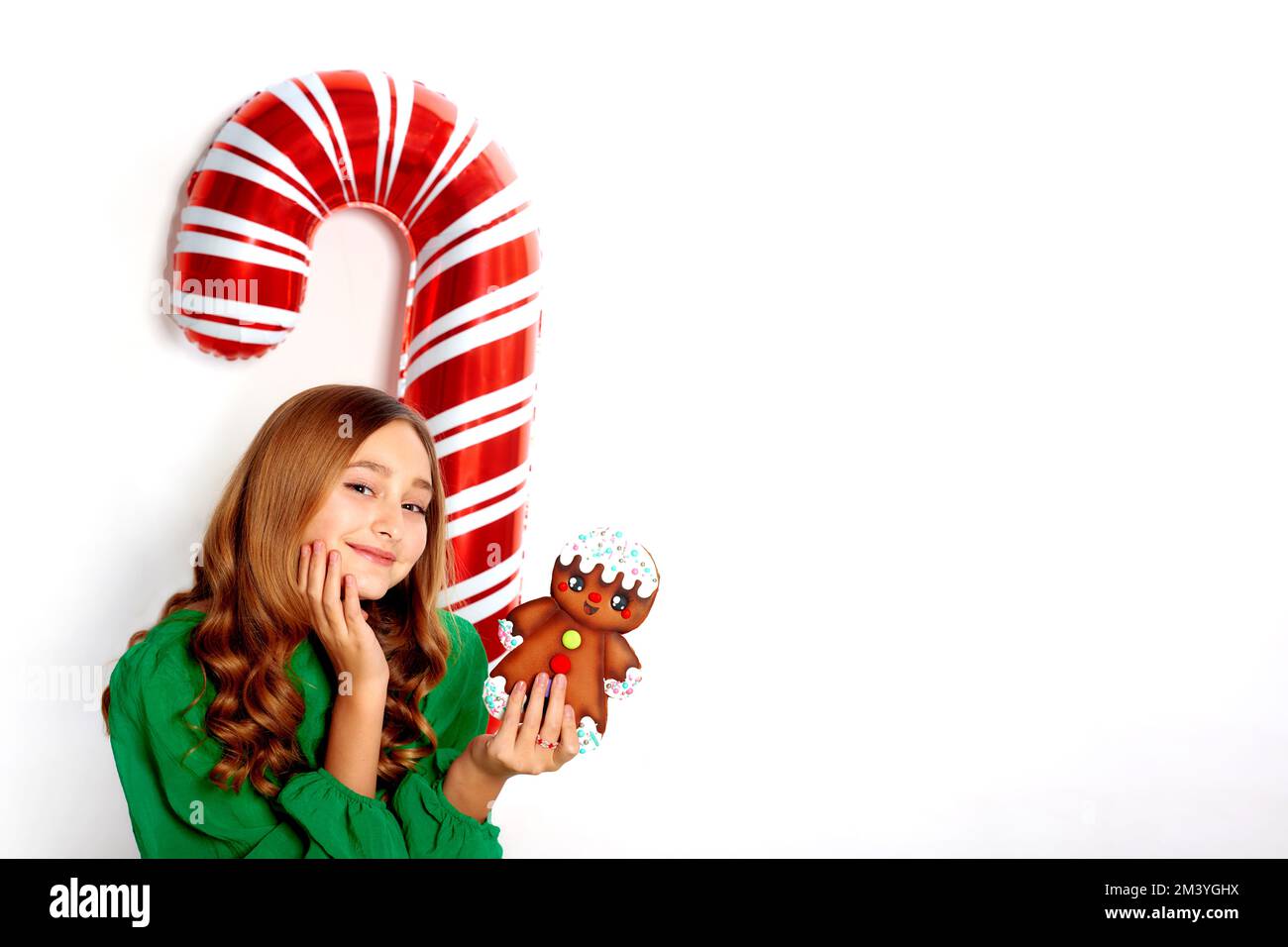 fancy girl teen holds Christmas gingerbread man on inflatable shape of ...