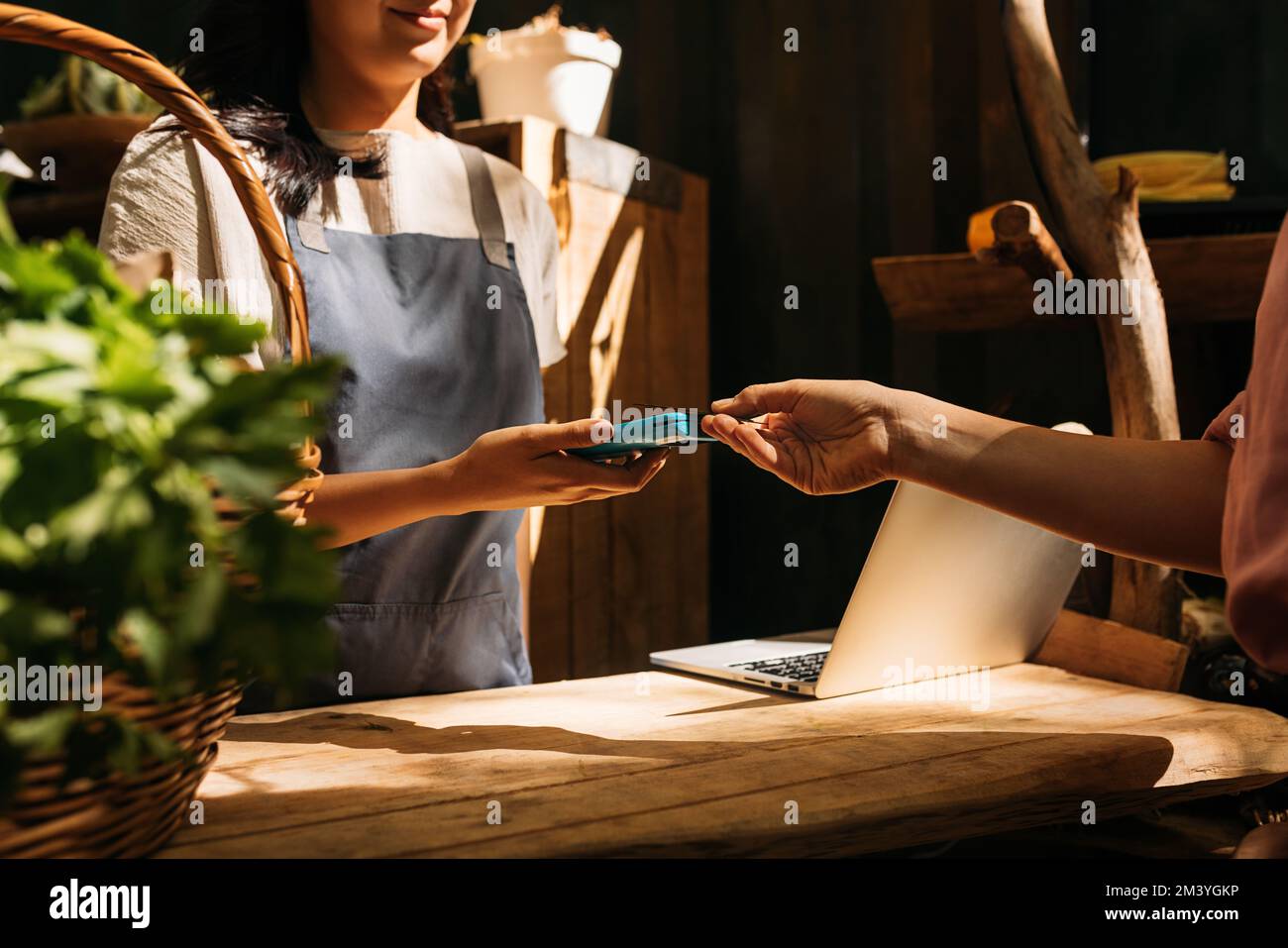 Vendor receiving payment from customer by card machine. Hands of ...