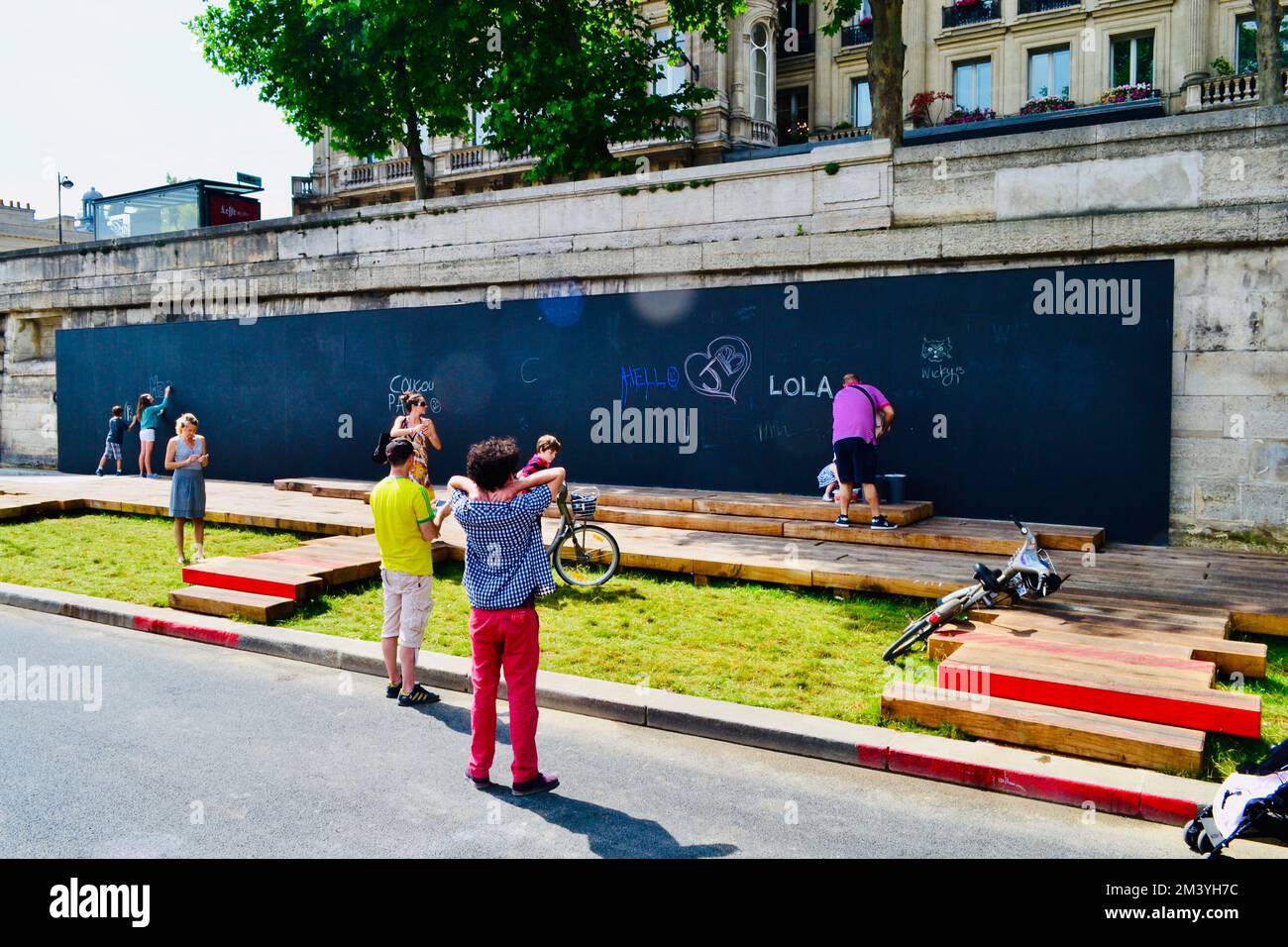 kids enjoy and participate at outdoor art wall in Paris Stock Photo - Alamy