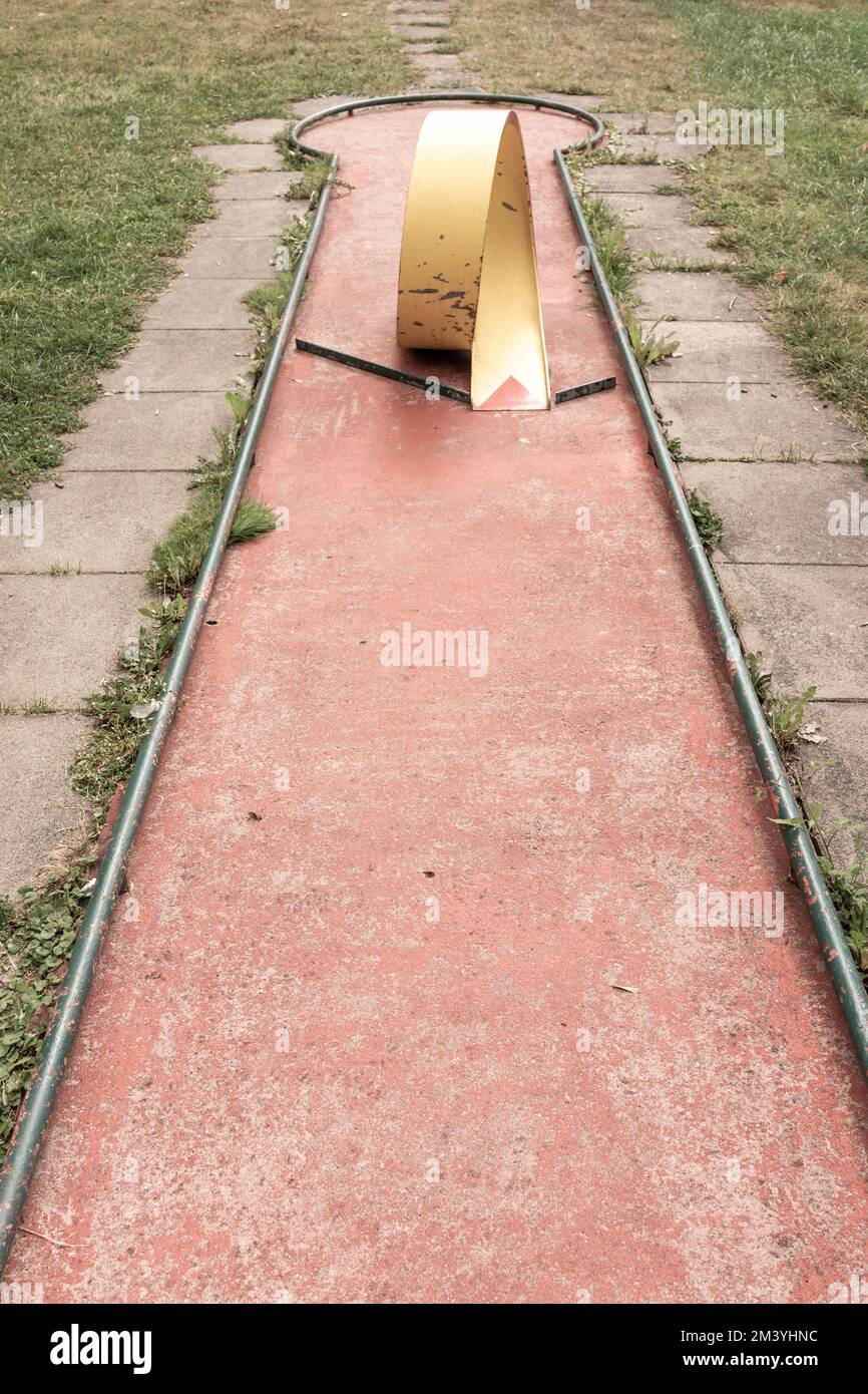 A vertical of a minigolf path, court with a weathered ironwork captured ...