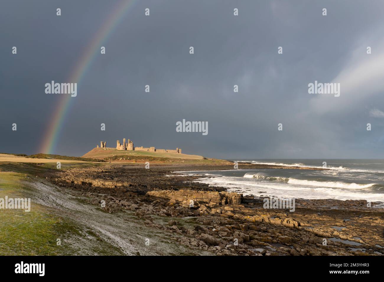 Craster Harbour and Dunstanburgh Castle. Craster, Northumberland, UK ...